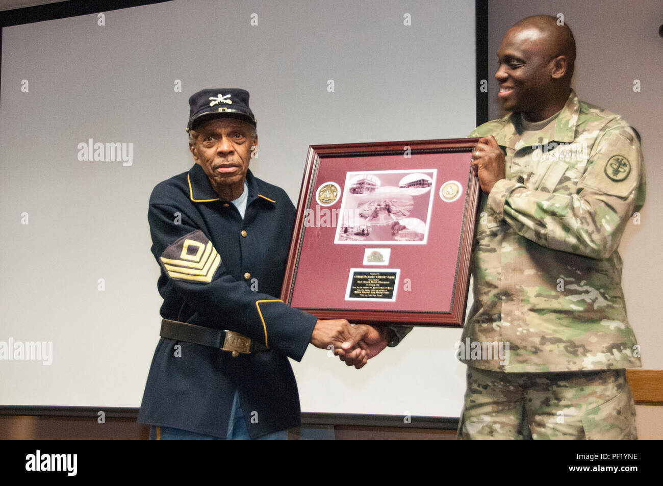 Charles Taylor (left), a Buffalo Soldier re-enactor and retired command sergeant major, holds a ...