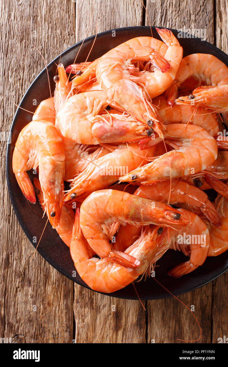 dish with boiled king prawns close-up on a plate. Food background ...
