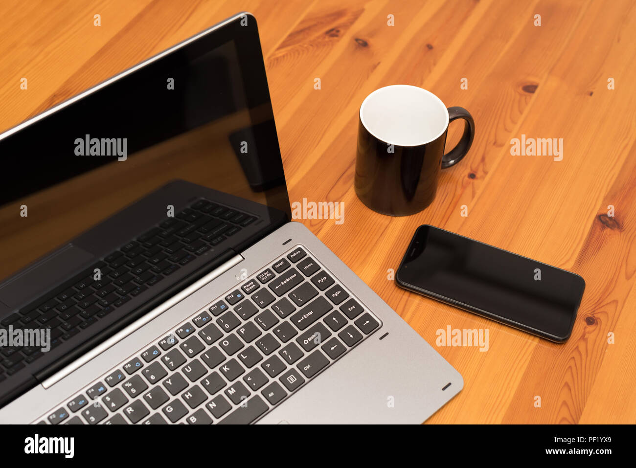 Wooden office desk table with laptop, cup and smartphone. Top view ...
