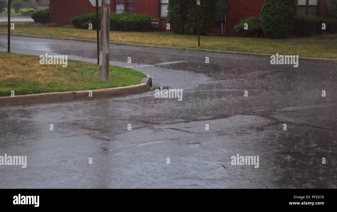 Raindrops are falling on the road. Summer rain drops falling on the ...