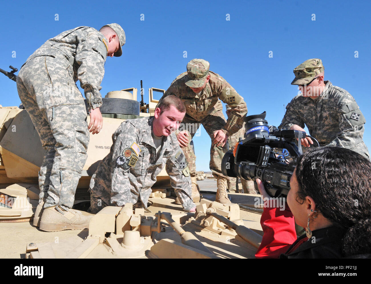 Joshua Hetherington is assisted into the driver's hatch of an M1 Abrams ...