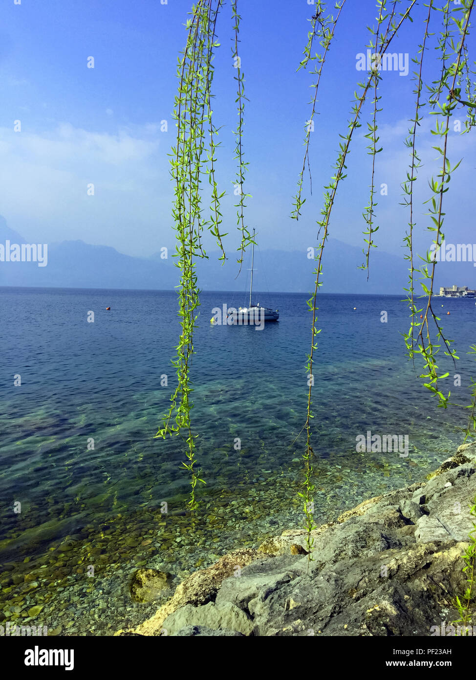 Small yacht at blue lake, spring, Lago di Garda, Italy Stock Photo - Alamy