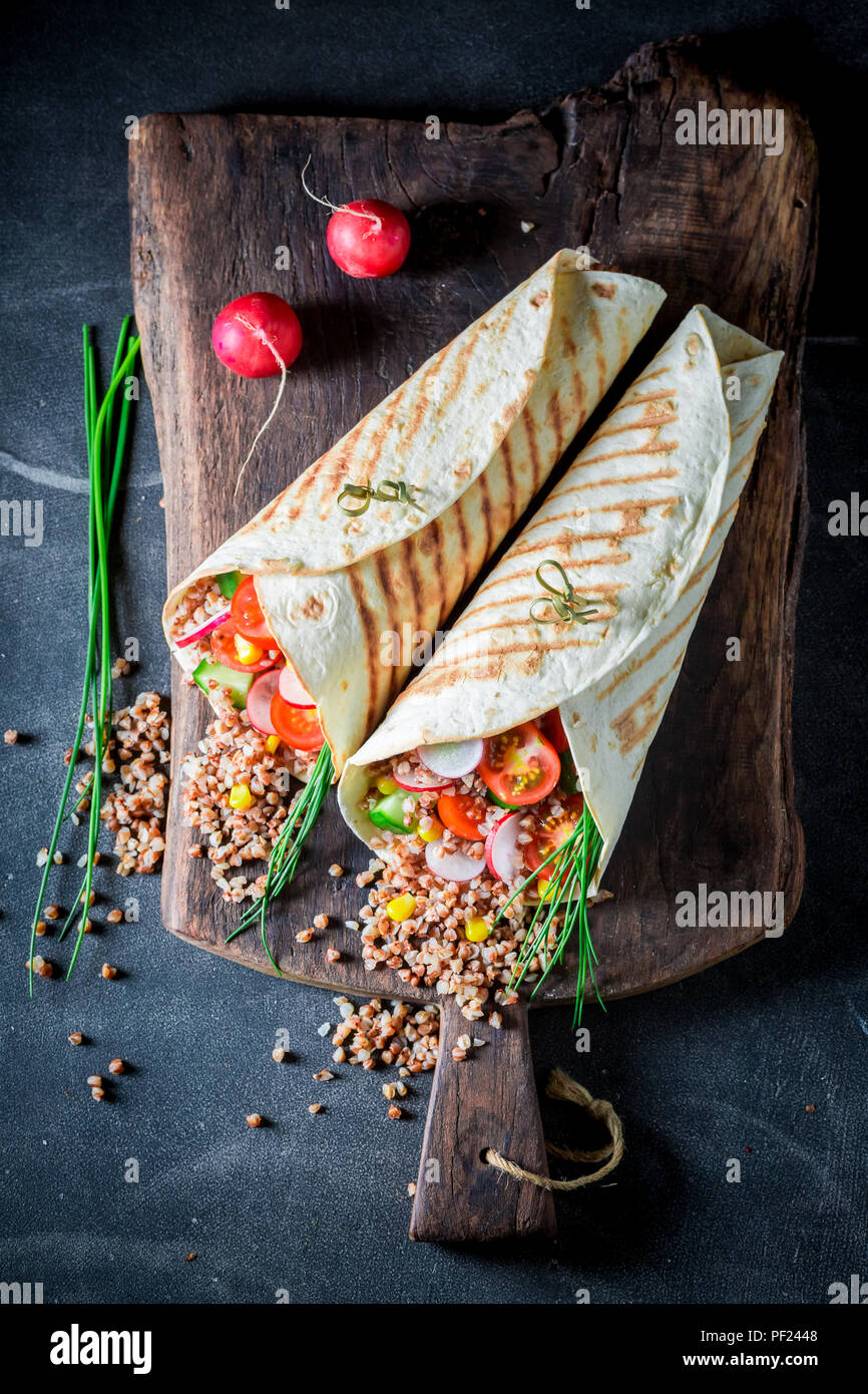Top view of vegetarian tortilla with groats and cherry tomatoes Stock ...