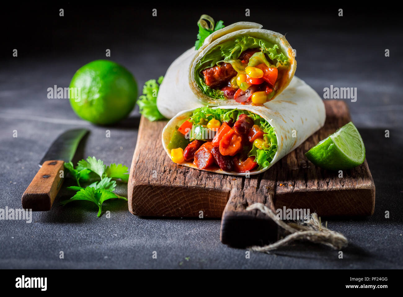 Spicy burrito made of lettuce and vegetables with red salsa Stock Photo ...