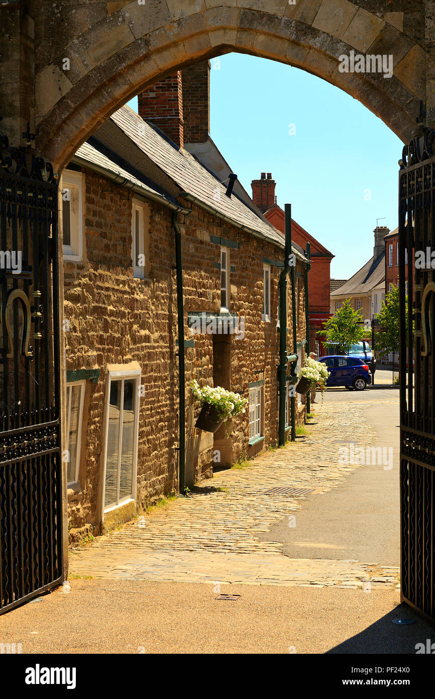 Period Stone Cottages through the arch gateway to Oakham Castle ...