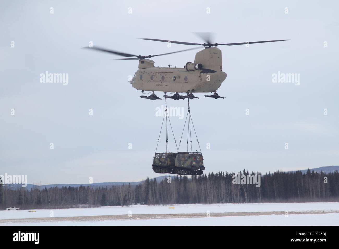 A Small Unit Support Vehicle (SUSV) is sling loaded to a CH-47 Chinook ...