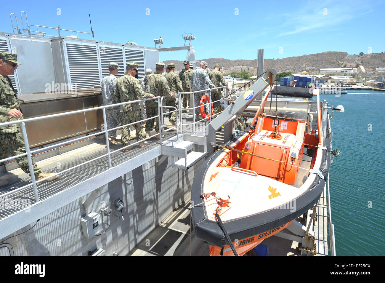 Troopers from Joint Task Force Guantanamo pass by a fast-rescue boat ...