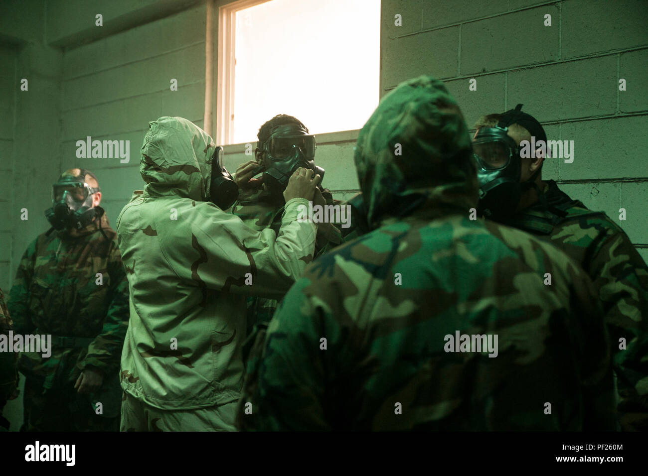 U.S. Marine Pfc. Quiton Nurse adjusts a Marine’s M50 Protective Joint ...