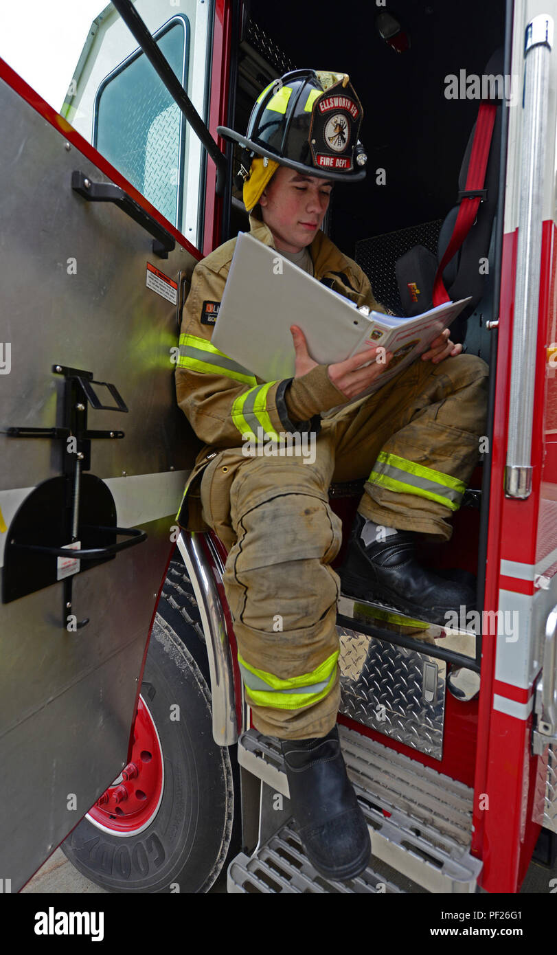 A firefighter from the 28th Civil Engineer Squadron reads a fire safety ...