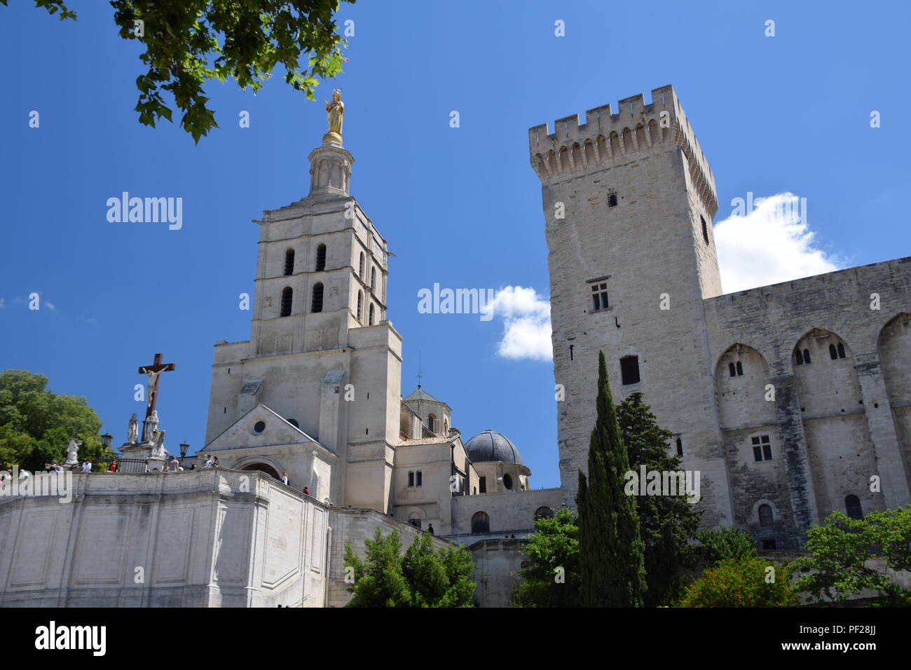 The historic Palais des Papes and surrounding sculptures and ...
