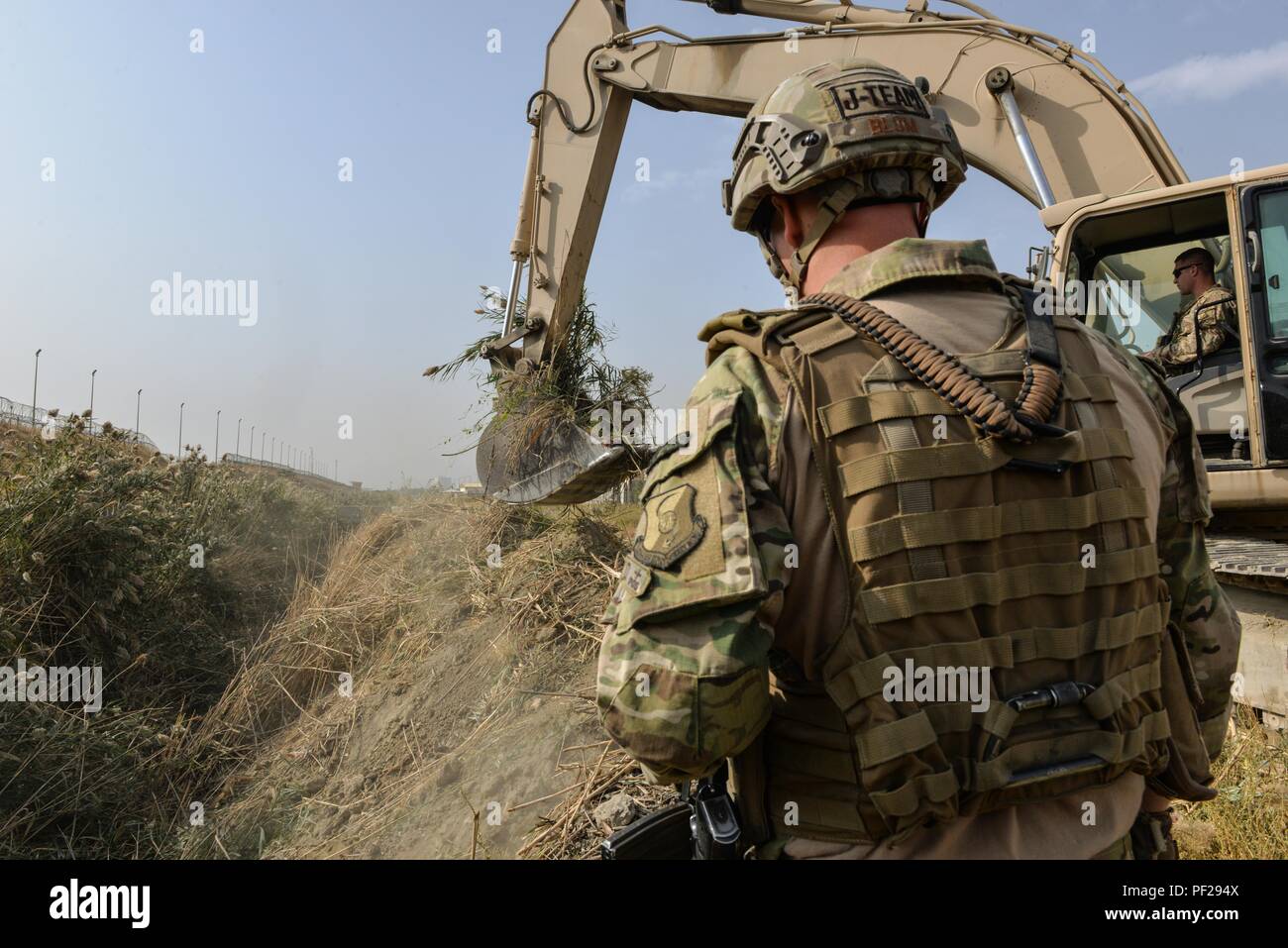 Capt. Erik Blum watches as Master Sgt. Thomas Ryan removes reeds from a ...