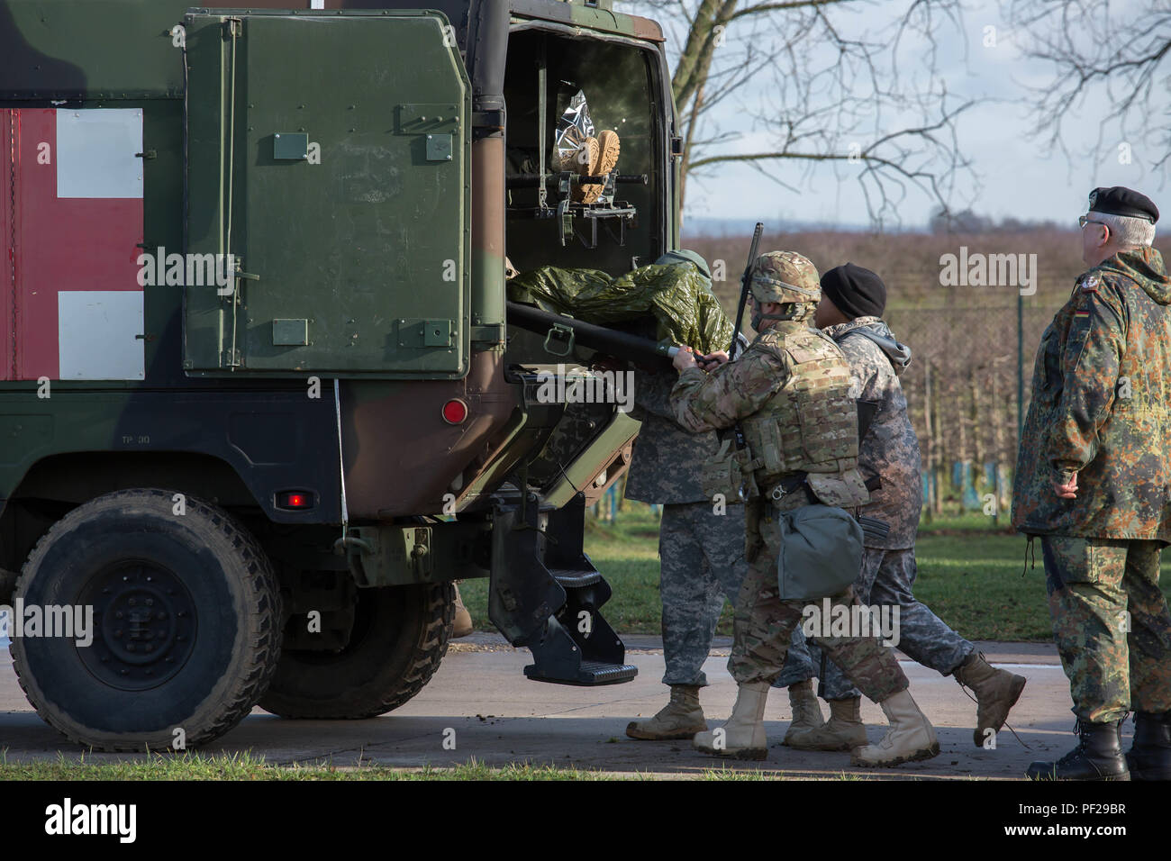 U.S. Army soldiers load casualties into a field ambulance during the ...