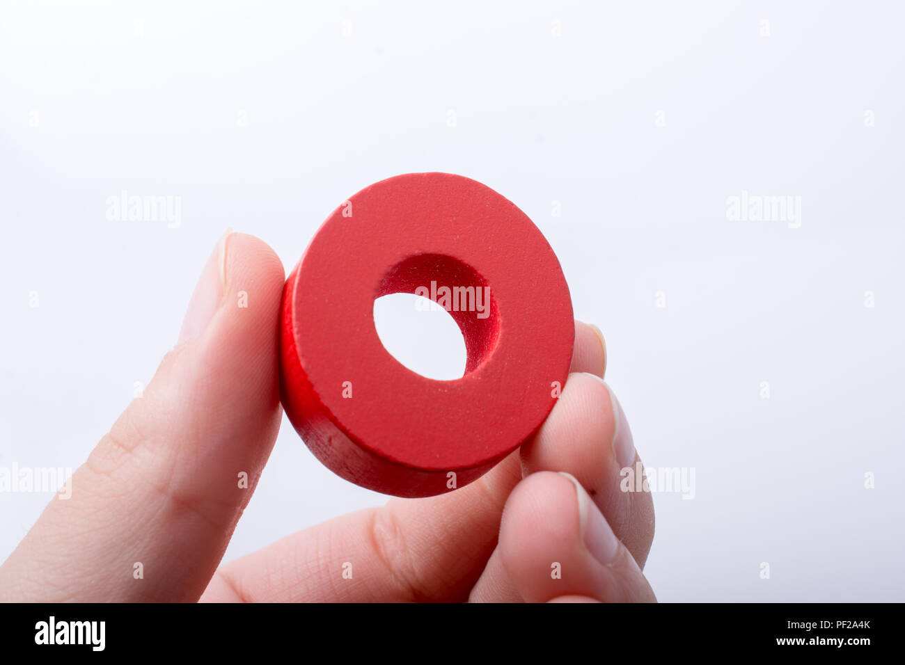 Hand holding letter cube O of made of wood Stock Photo - Alamy