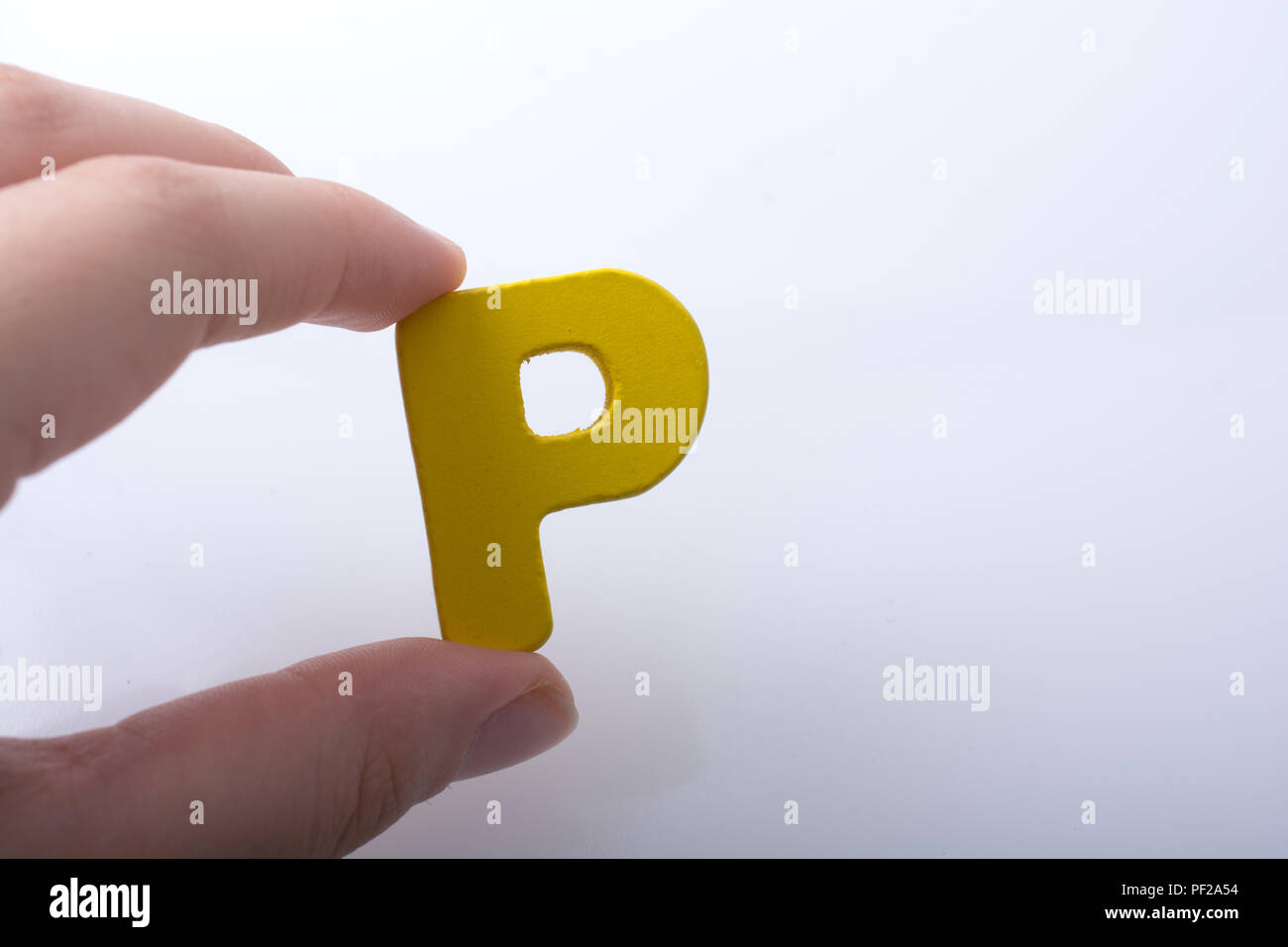 Hand holding letter cube P of made of wood Stock Photo - Alamy