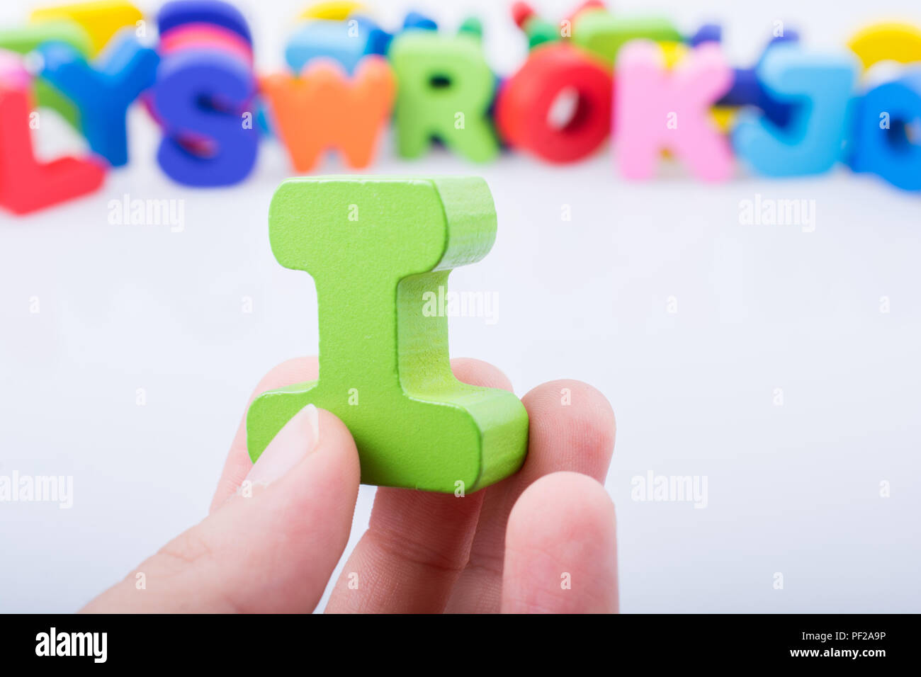 Hand holding Letter cube of I of Alphabet Stock Photo - Alamy