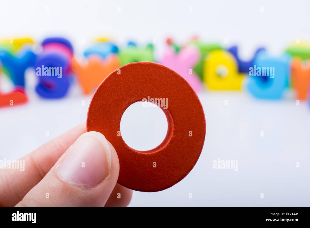 Hand holding letter cube O of made of wood Stock Photo - Alamy