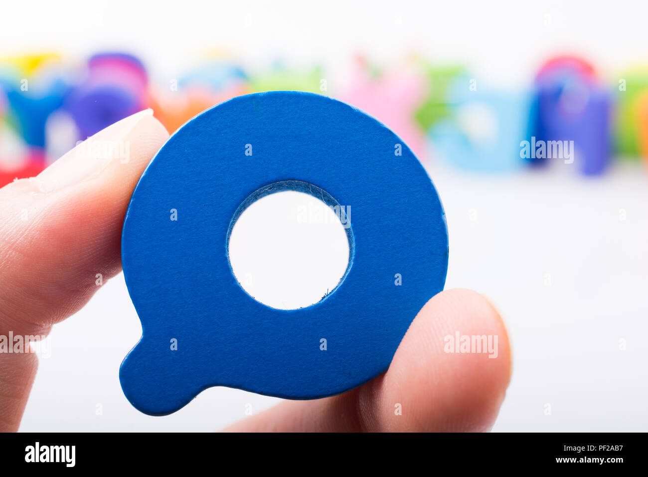 Hand holding letter cube Q of made of wood Stock Photo - Alamy