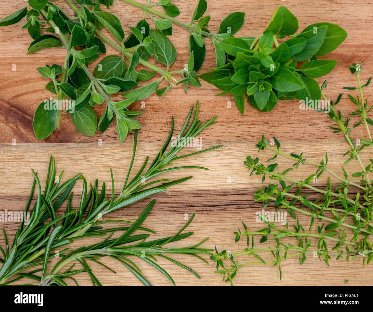 Wooden board with fresh herbs. top down view Stock Photo - Alamy