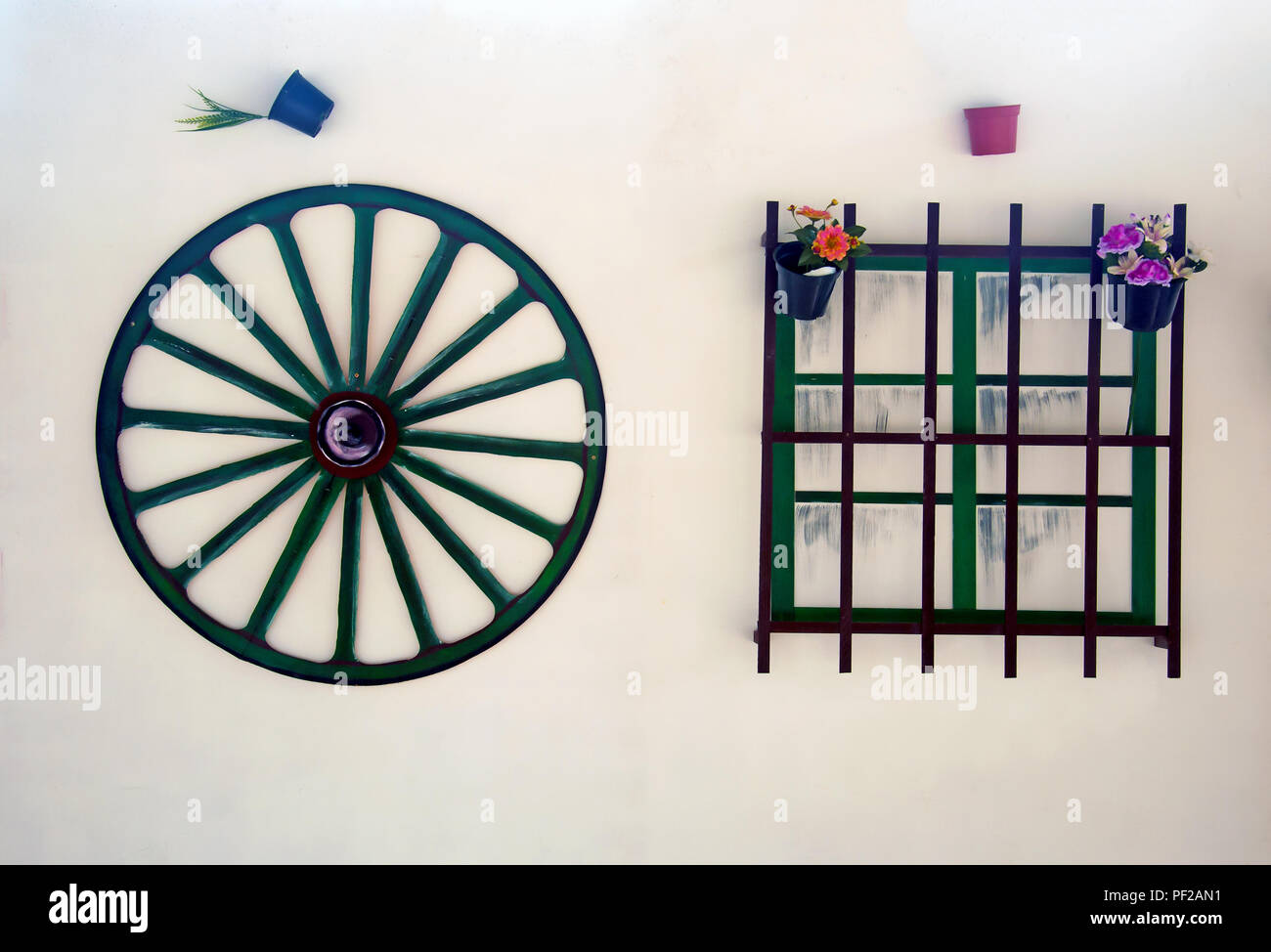 Sham cartwheel, window and flowers on the white wall Stock Photo - Alamy