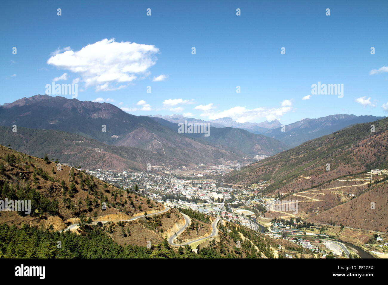 Winding or curved asphalt road on the hill with view of Thimphu city ...