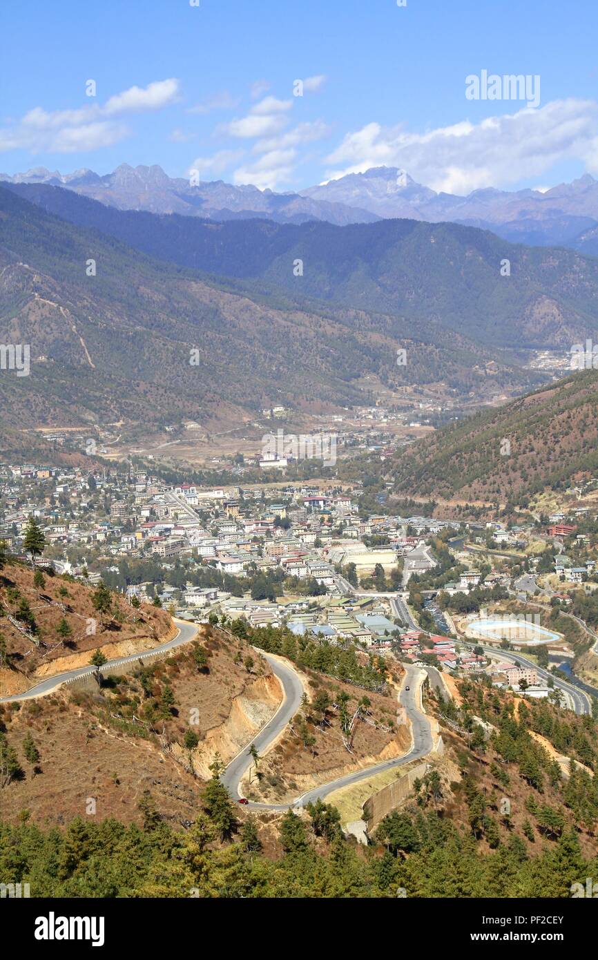 Winding or curved asphalt road on the hill with view of Thimphu city ...