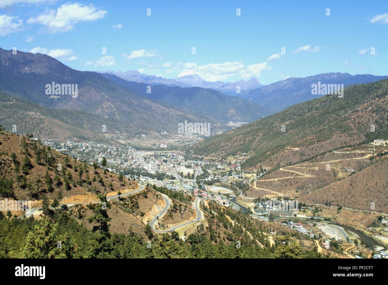 Winding or curved asphalt road on the hill with view of Thimphu city ...