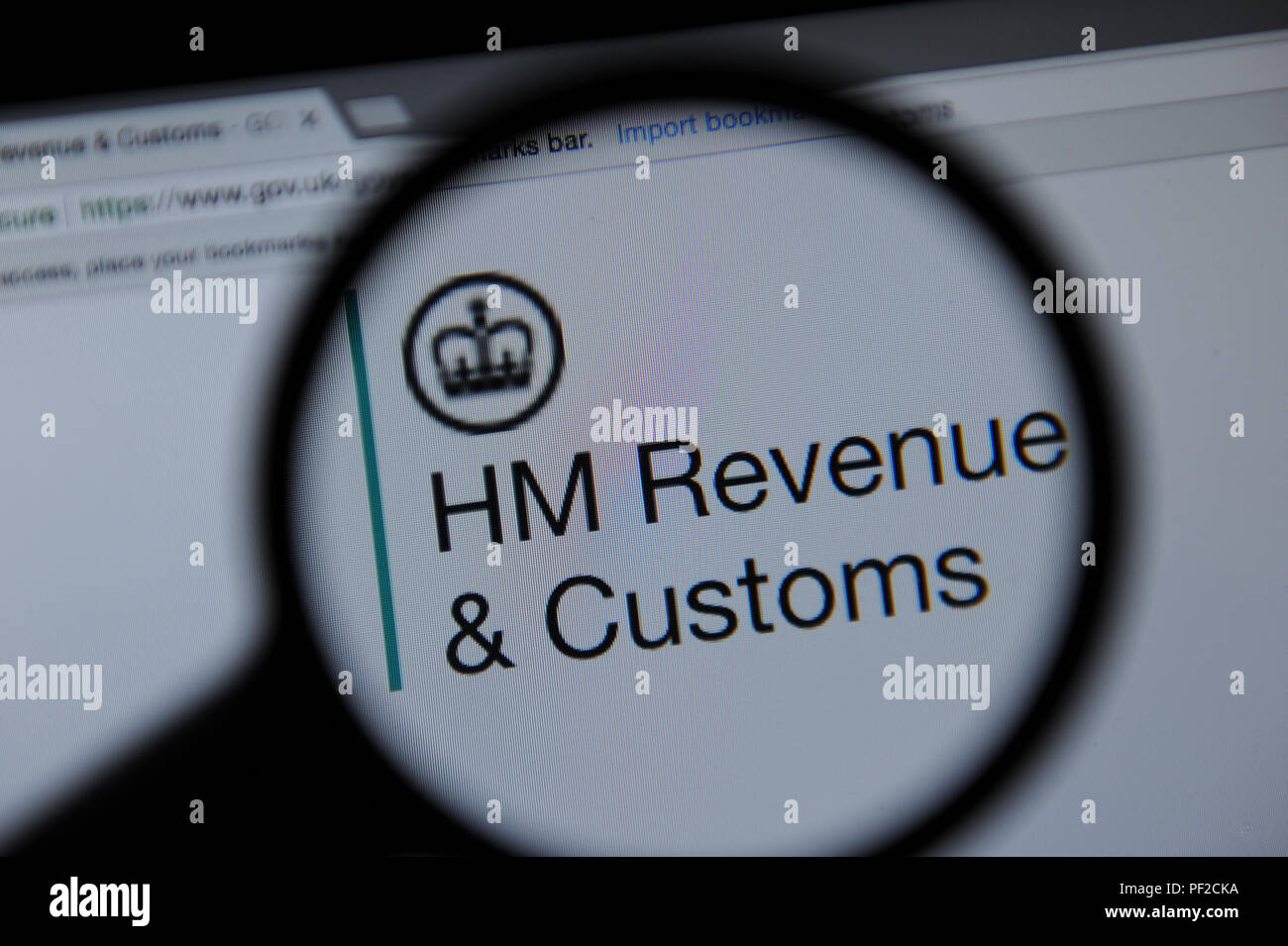 The HMRC website seen through a magnifying glass Stock Photo - Alamy