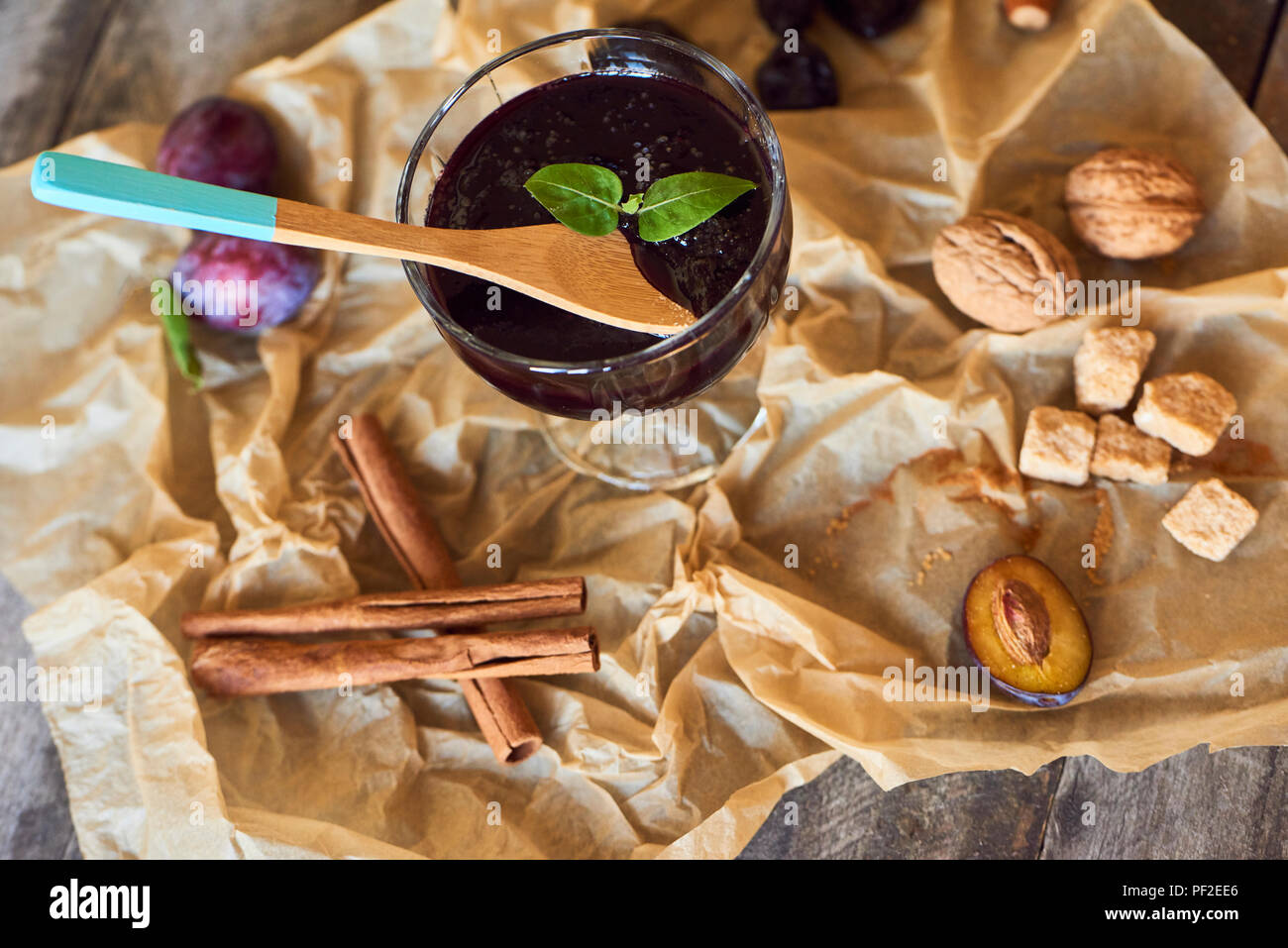 plum jam with spoon cinnamon, fresh fruits, nuts and cane sugar Stock ...