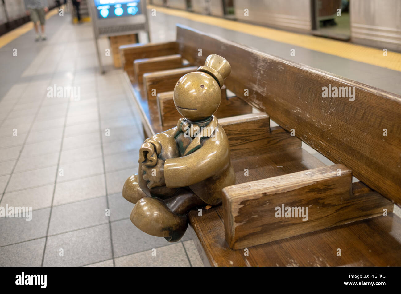 a little man with a big money bag sitting quietly on a bench Stock ...