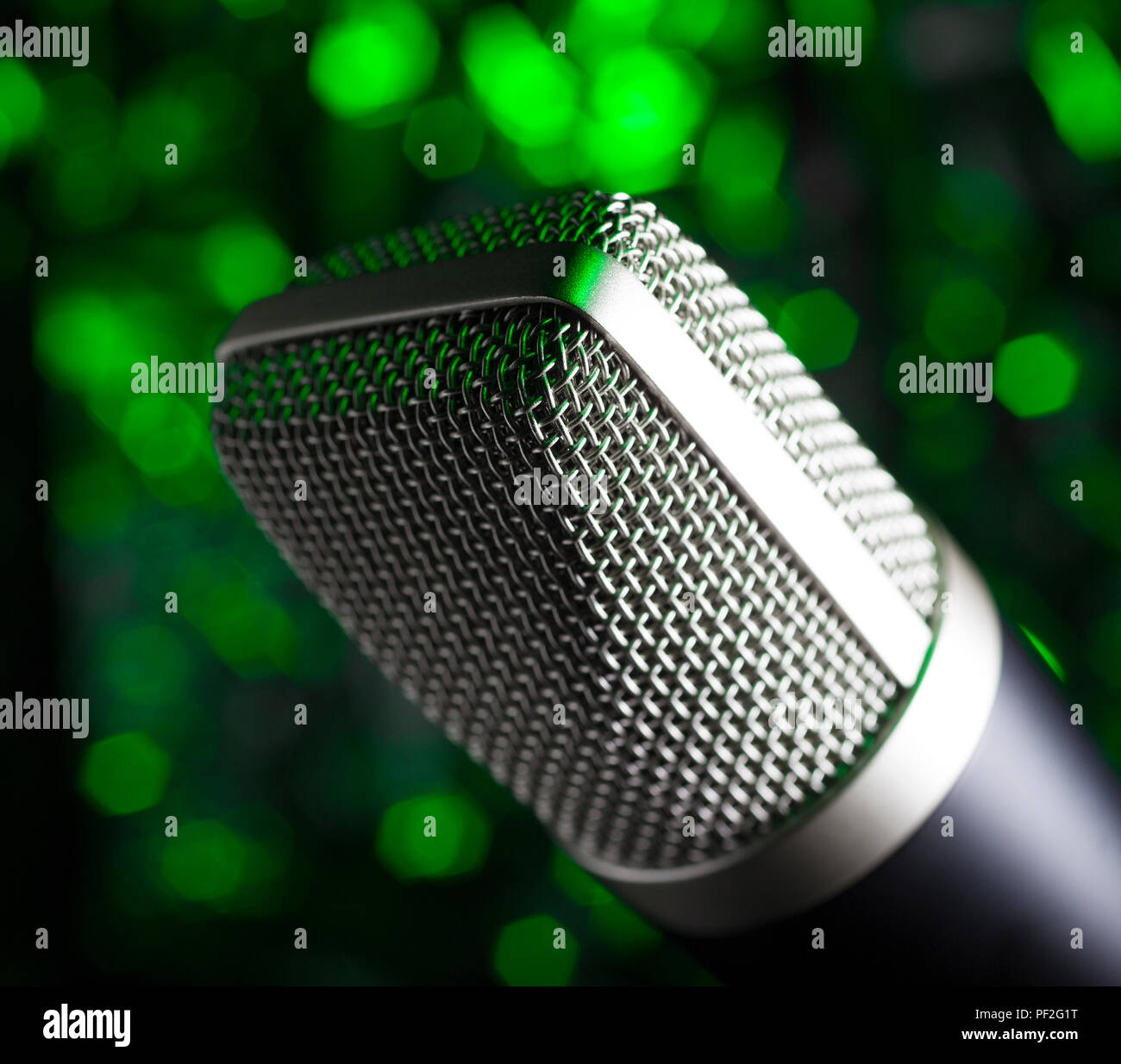 Wire mesh covered microphone with a blurry green background Stock Photo ...