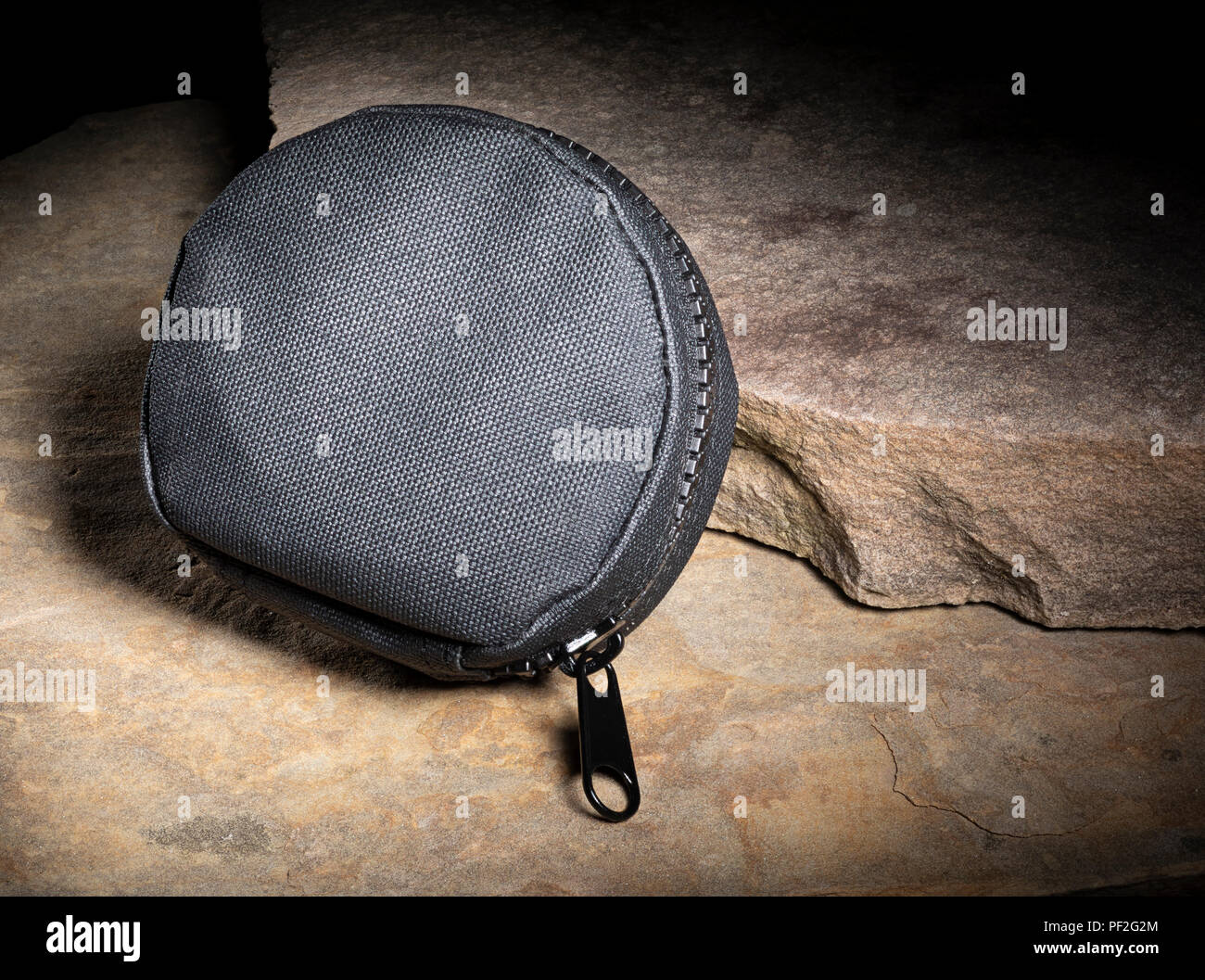Zippered black tactical pouch on a pair of rocks Stock Photo - Alamy