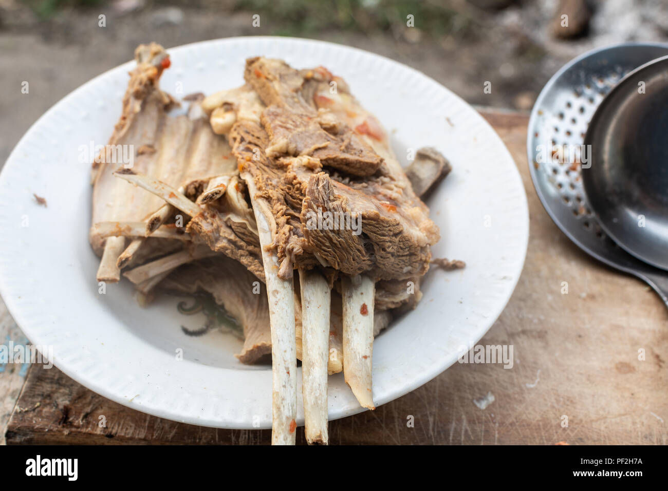 Boiled lamb in a plate on a wooden board Stock Photo - Alamy
