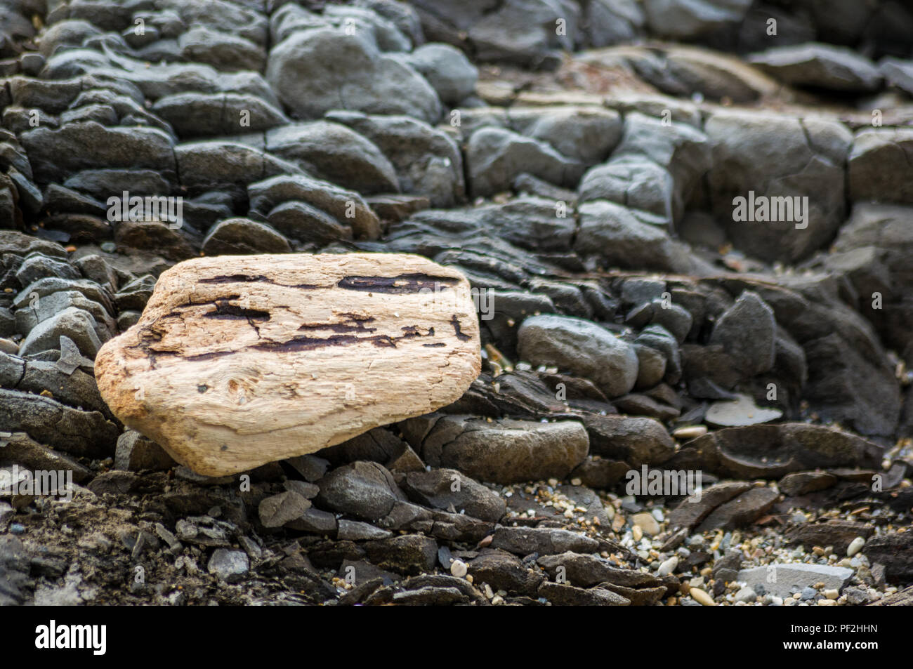 pebble stones on the sea beach on a warm summer day, the rolling waves ...