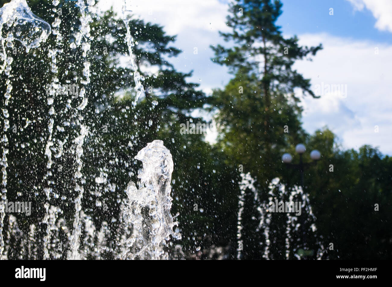Fountain in city park on hot summer day, beautiful bright streams of ...