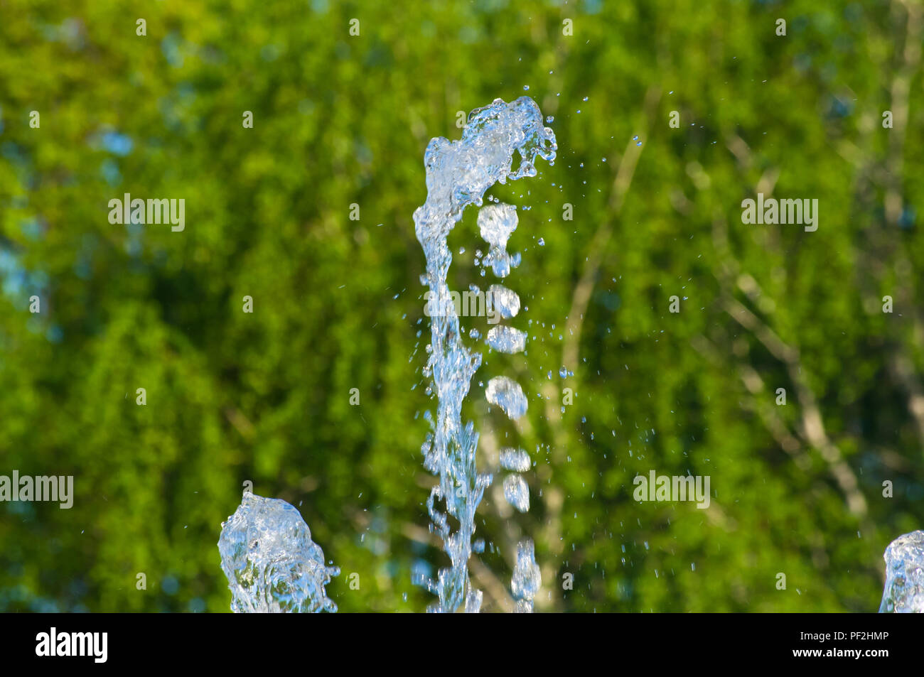 Fountain in city park on hot summer day, beautiful bright streams of ...