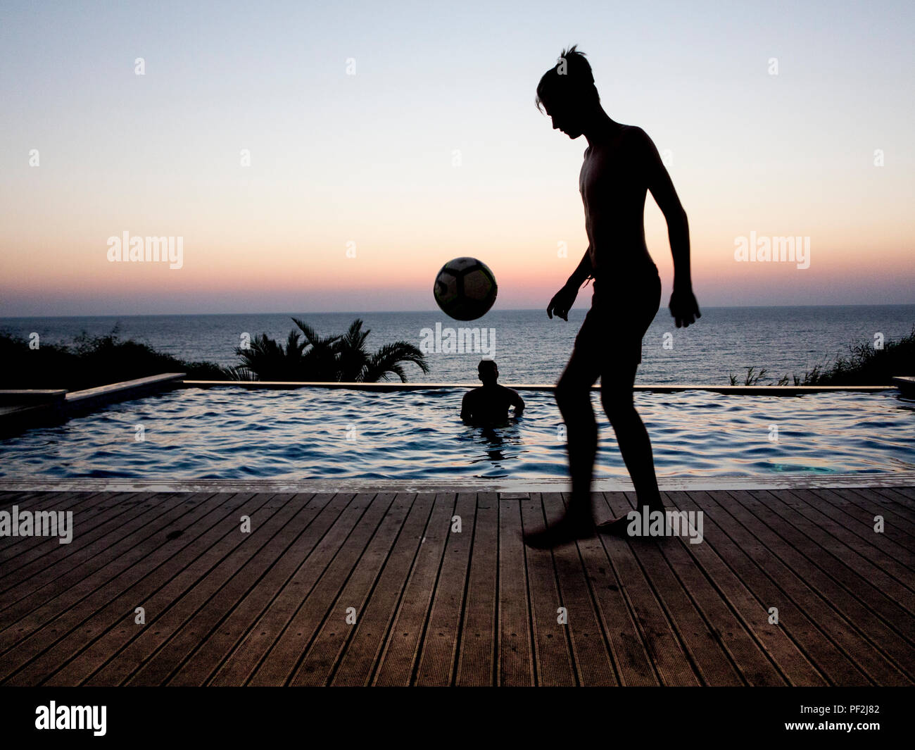 Silhouette boy kicking soccer ball hi-res stock photography and images ...