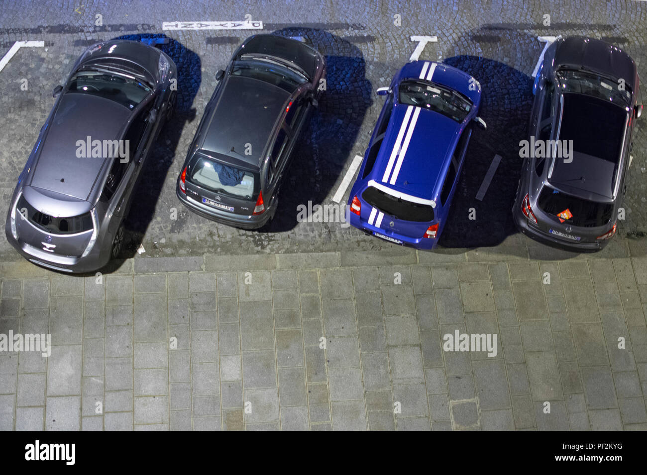 Four cars parked in a street of Paris Stock Photo - Alamy