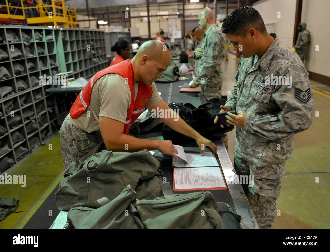 Airmen from the 940th Air Refueling Wing are issued deployment gear ...