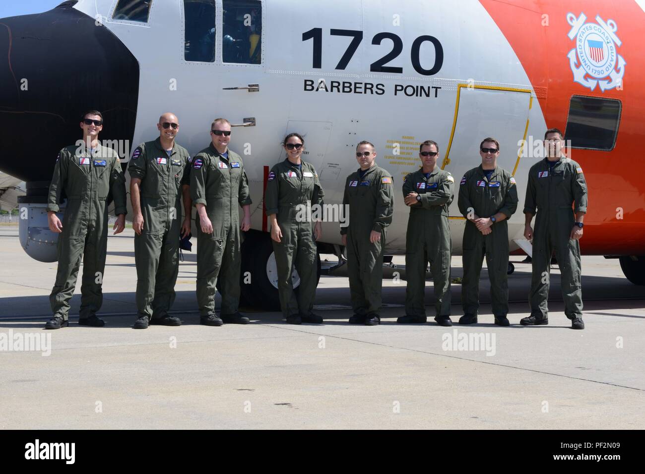 An HC-130 Hercules aircrew stationed at Air Station Barbers Point stand ...