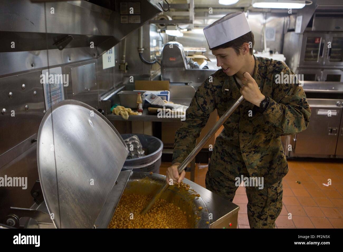 1st Lt. Karoline Foote stirs a pot of baked beans in preparation for a ...