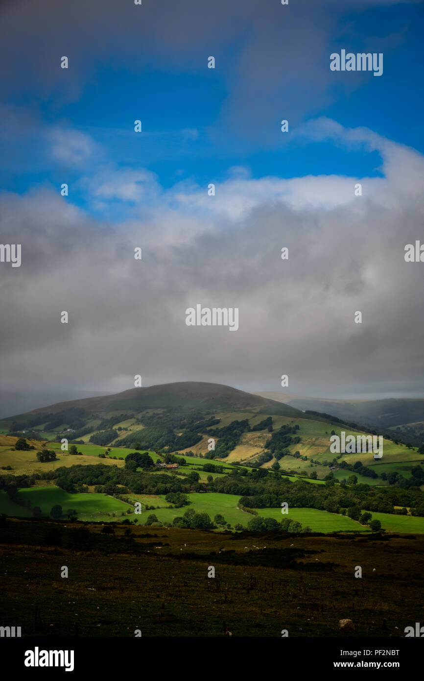 The rain clouds coming over the mountains at the Welsh Countryside in ...