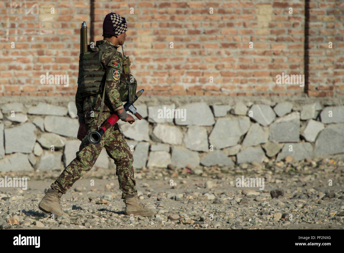 An Afghan National Army soldier walks around with a RPG and rockets ...
