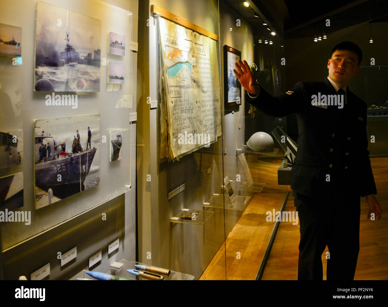 Republic of Korea Navy Petty Officer 1st Class Samuel Jung shows photos ...
