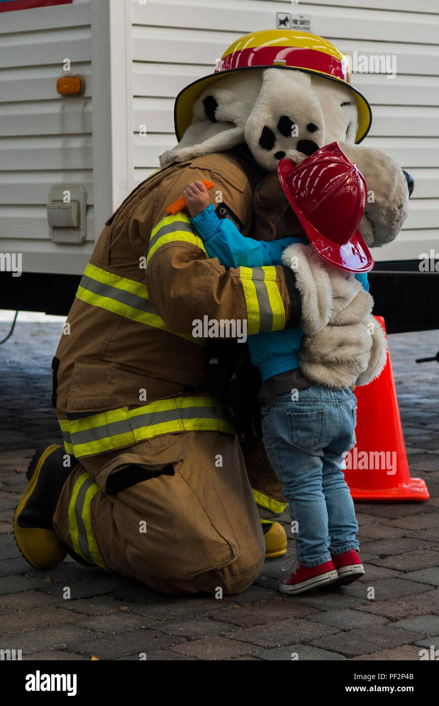 Sparky, the 52nd Civil Engineer Squadron firefighters’ mascot, hugs a ...