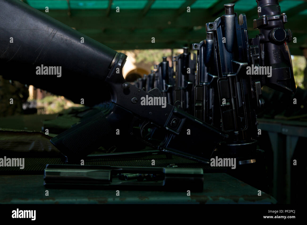 M16A4 service rifles hang from a table aboard Marine Corps Recruit ...