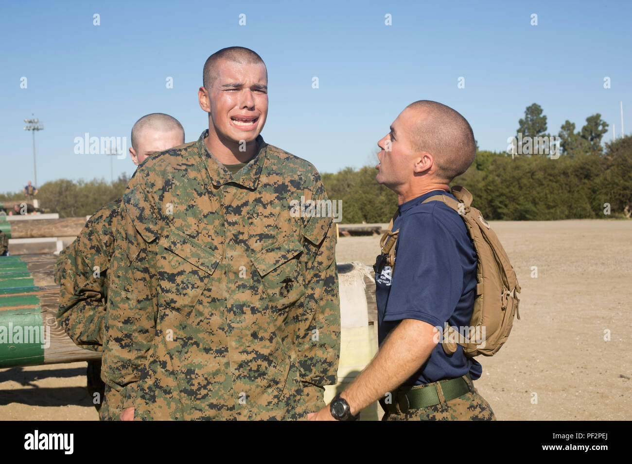 U.S. Marine Corps Staff Sgt. Jevon McKinnon, right, a drill instructor ...