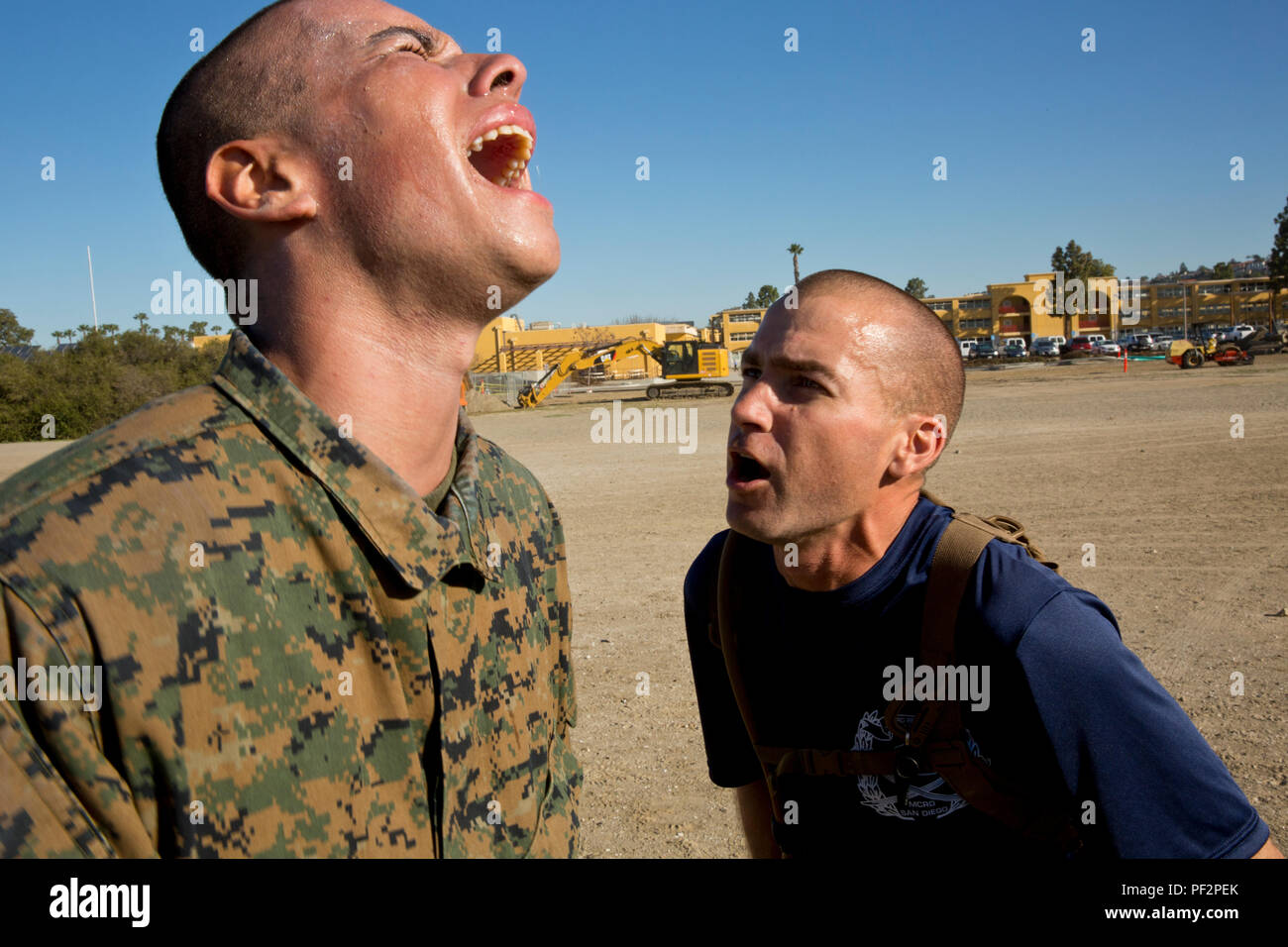 U.S. Marine Corps Staff Sgt. Jevon McKinnon, right, a drill instructor ...