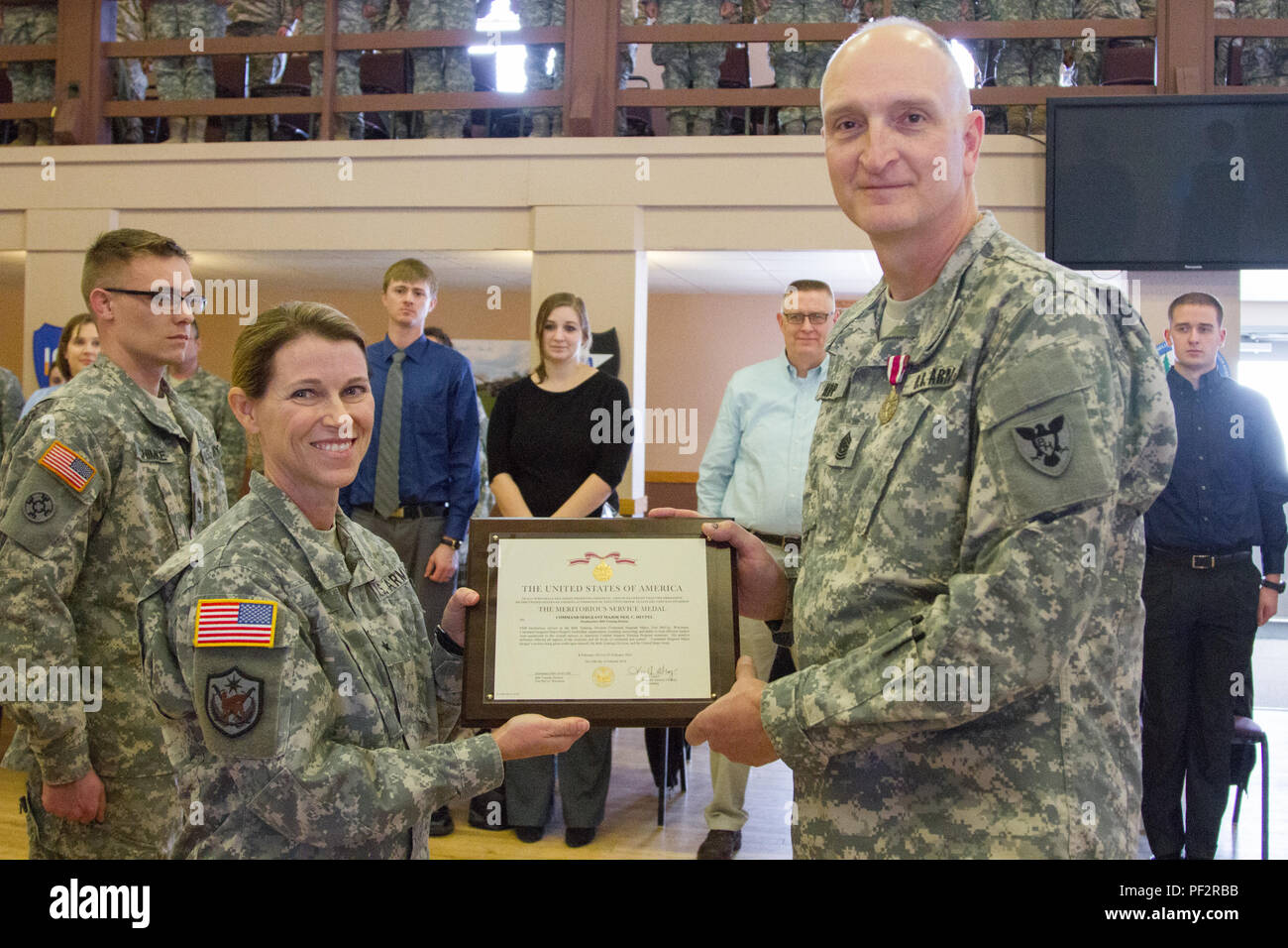Brig. Gen. Lee Gray presents the Meritorious Service Medal placard to ...