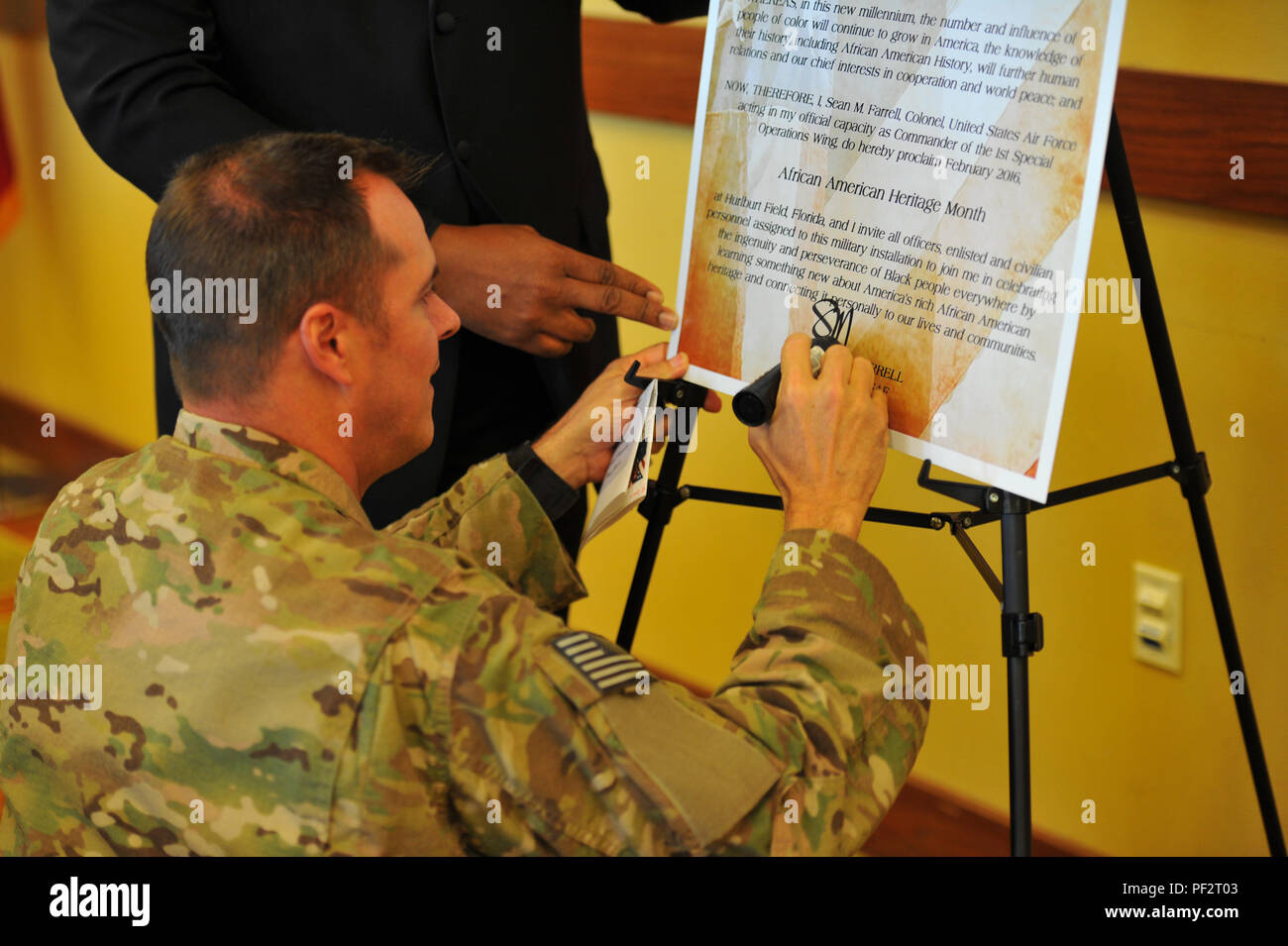 Col. Sean Farrell, commander of the 1st Special Operations Wing, signs ...