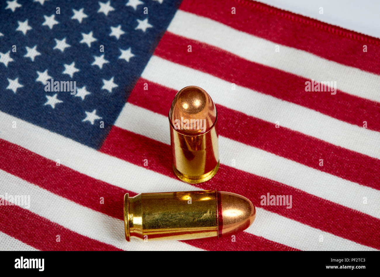 Two .45 caliber bullets laying on an American Flag Stock Photo - Alamy